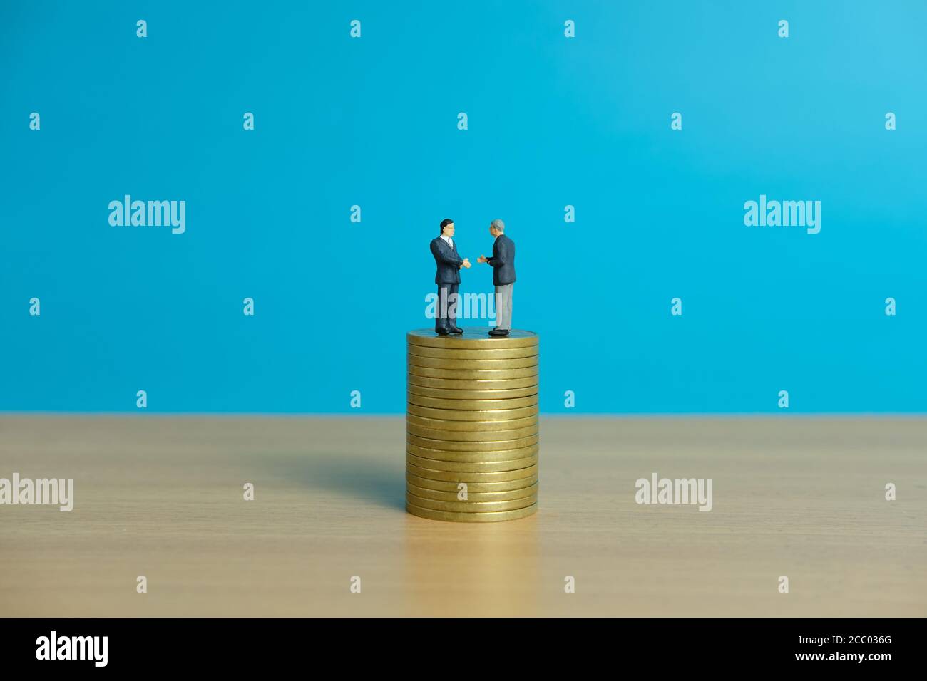 Miniature business concept - two businessman make an handshake for ...