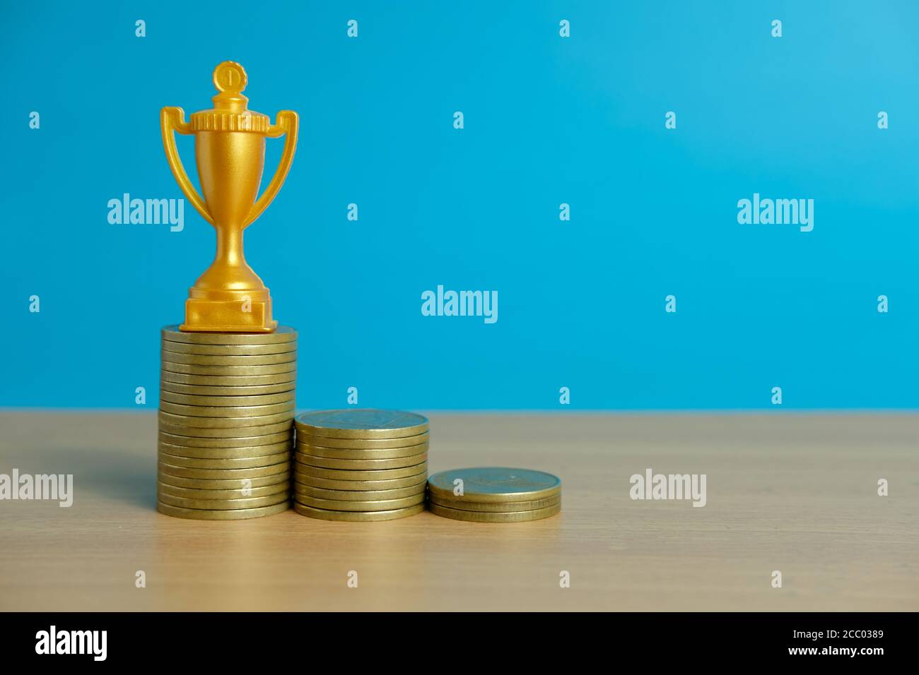 Miniature business concept - a trophy on staircase coin stack stairways ...