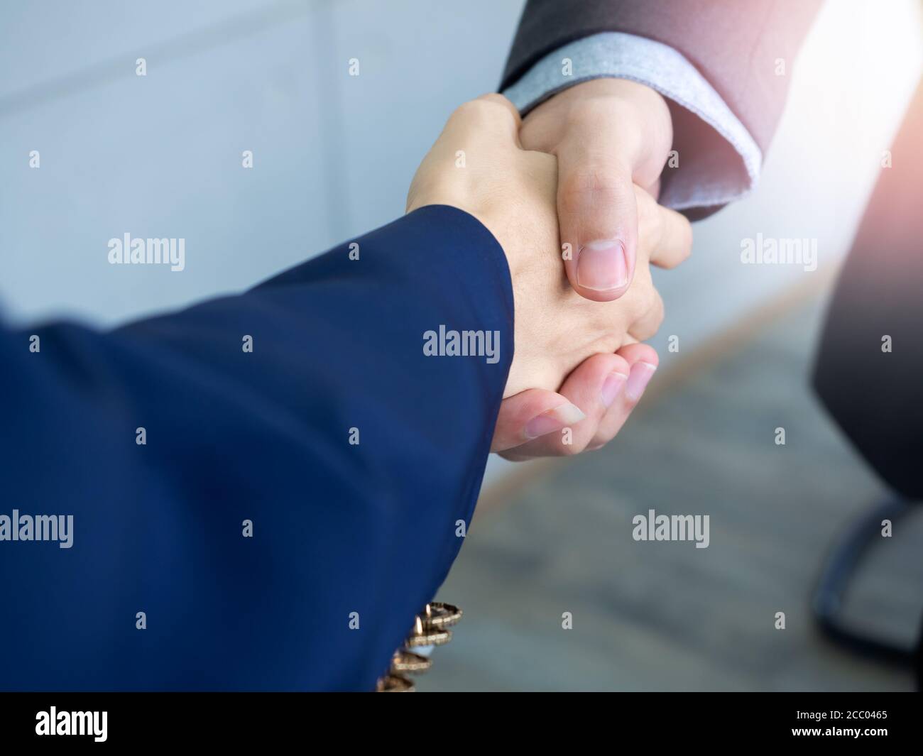 Businessman and businesswoman are shaking hands. Close up hand shake ...