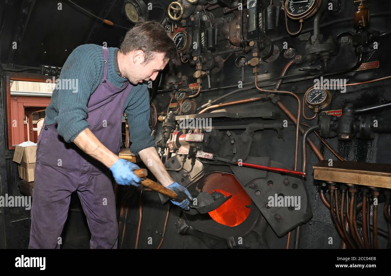 Wansford, UK. 15th Aug, 2020. Jack Colby feeds the fire with coal as ...