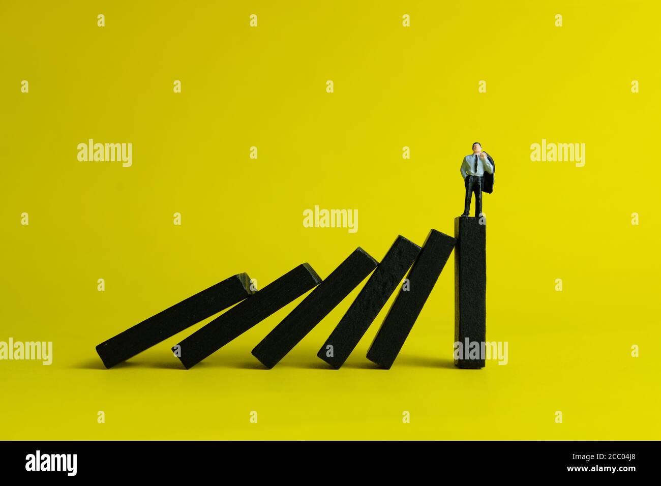 Miniature business concept - a businessman standing still on a single ...