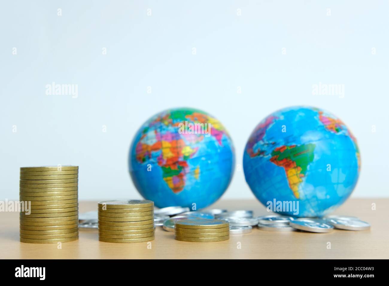 Global trade and financial concept - decreasing stack of coin in front ...