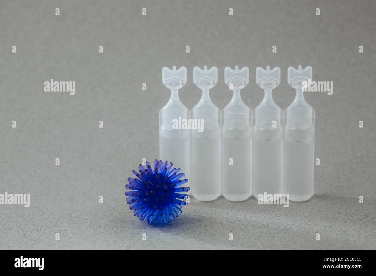Abstract model of a blue virus infection and medicine in an ampoule on ...