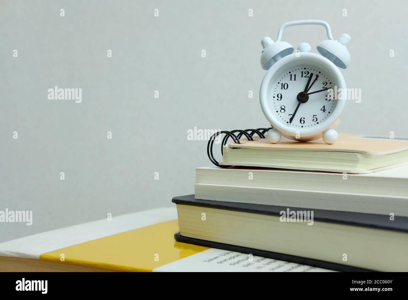 Office workload concept - stack of book with clock on the top Stock ...