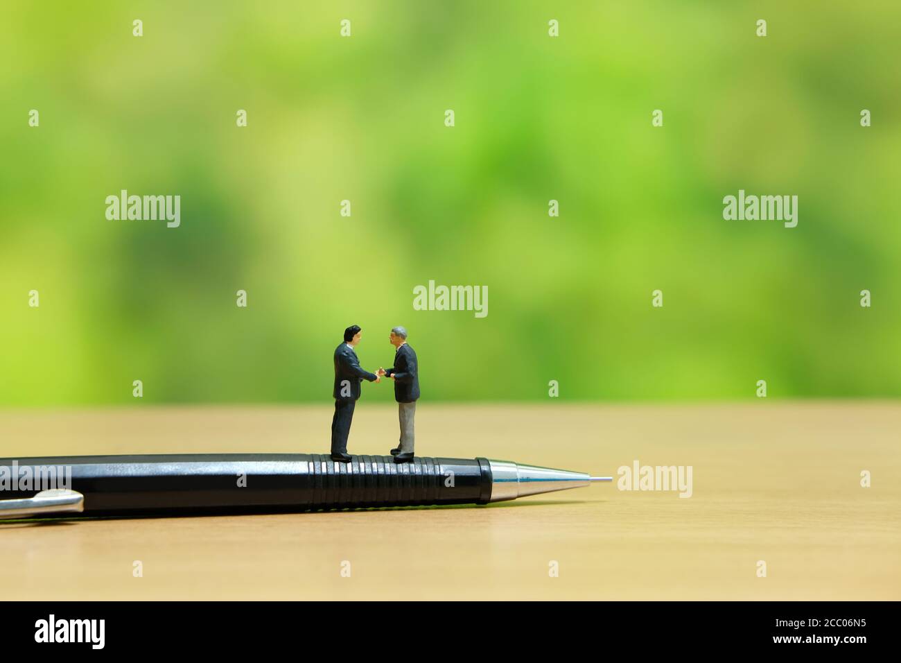 Business strategy conceptual photo - Two miniature businessman make ...