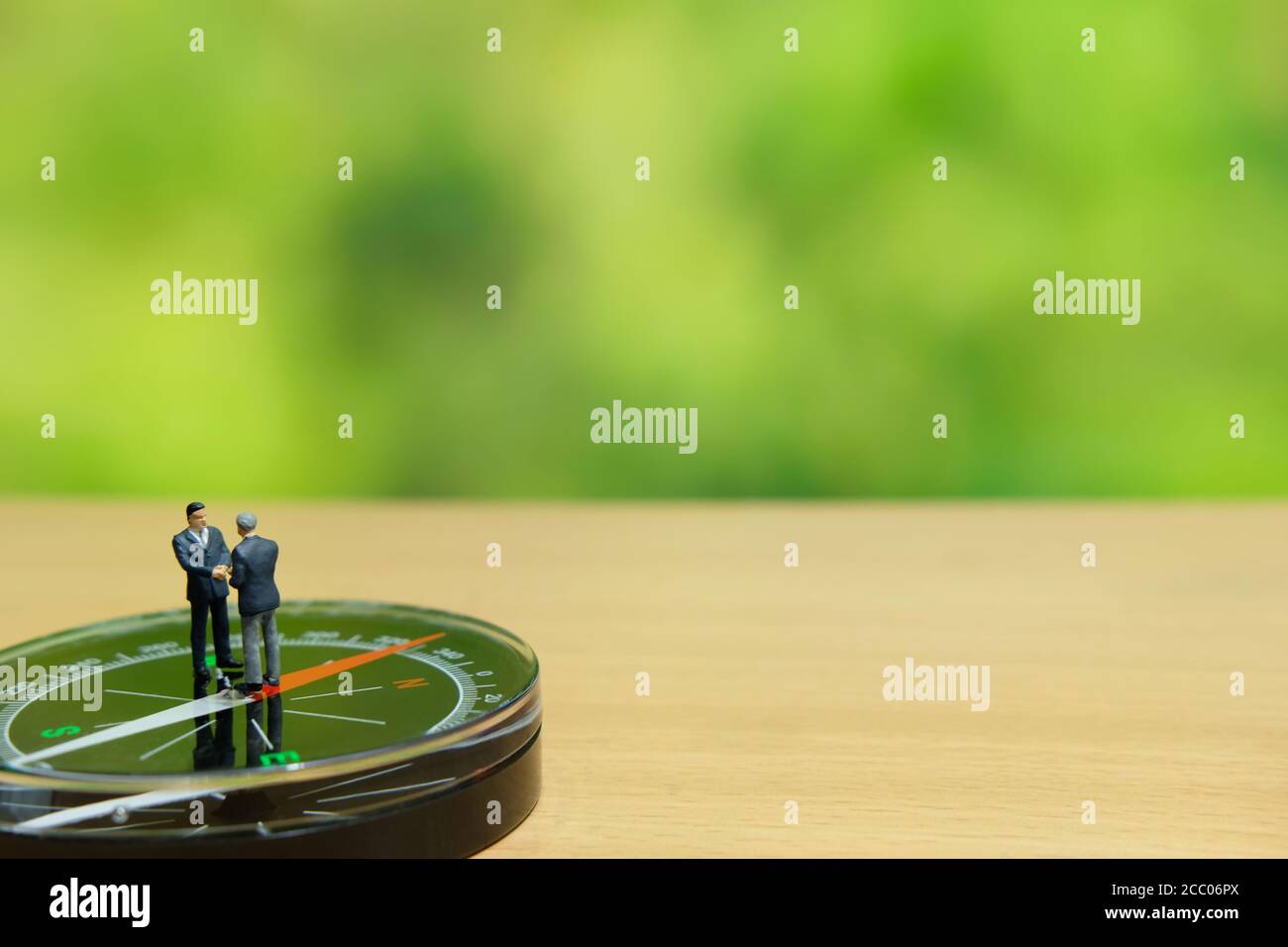 Business strategy conceptual photo - Two miniature businessman make ...