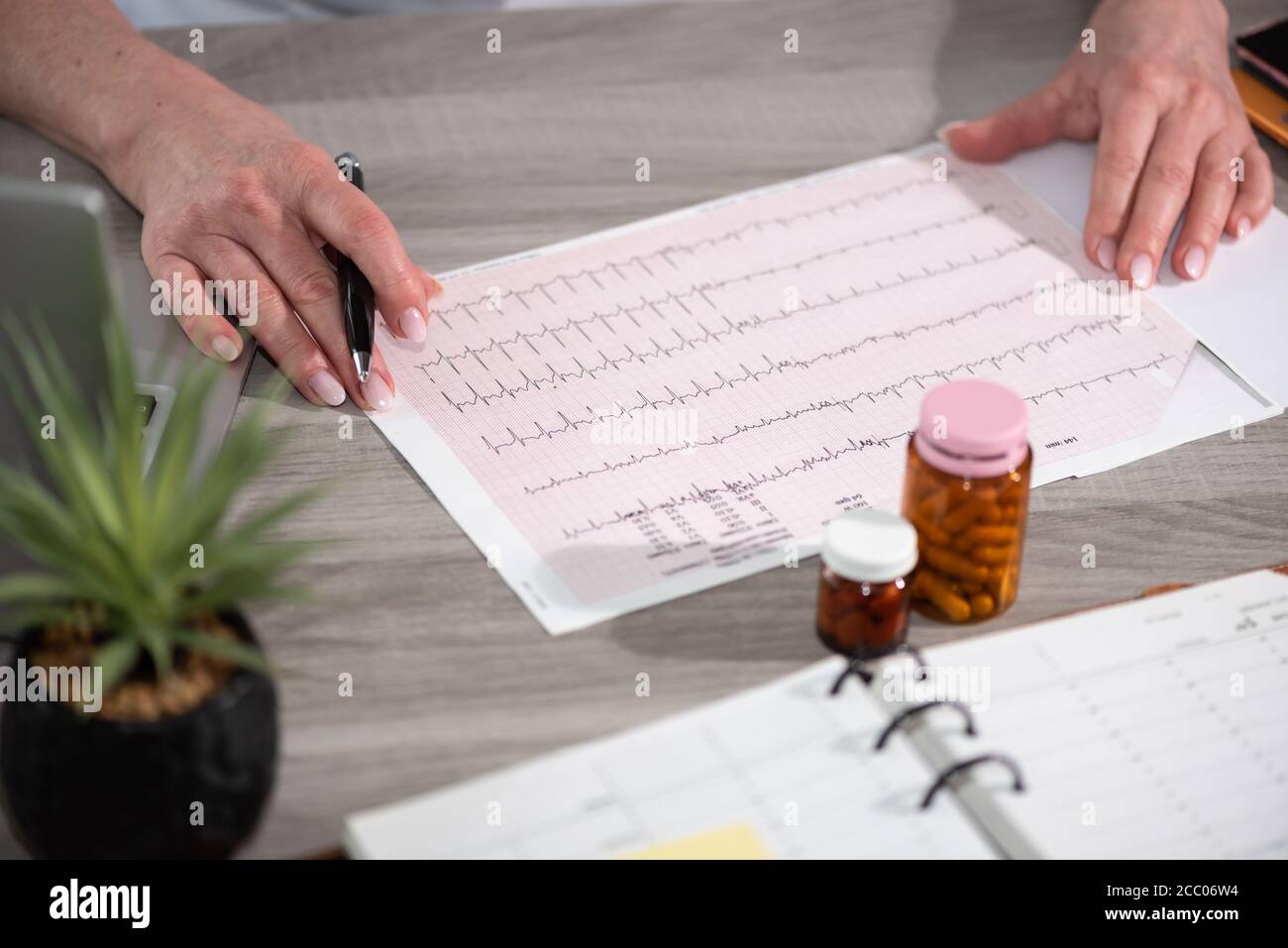 Female cardiologist examining an ecg graph in medical office Stock ...