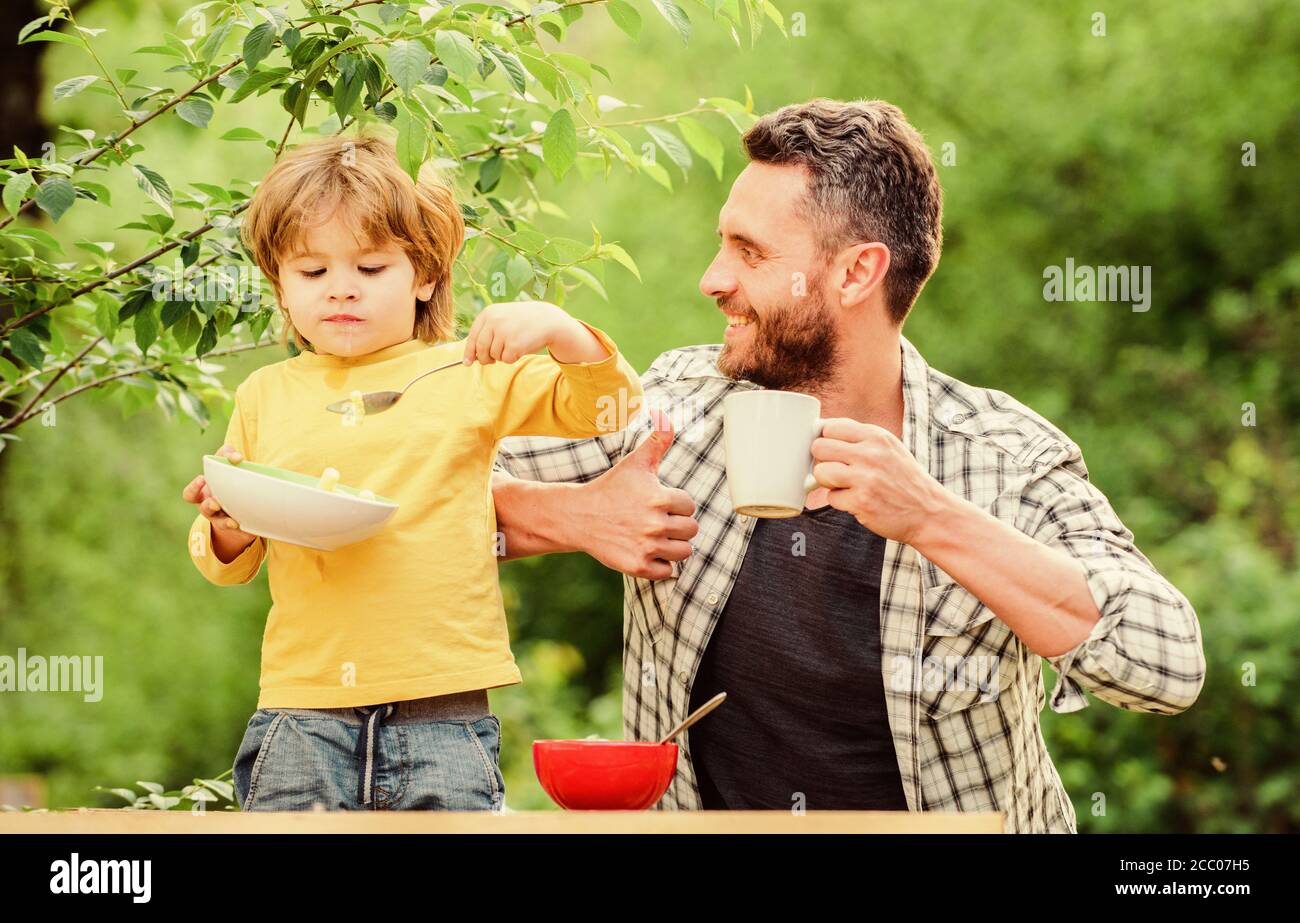 happy fathers day. Little boy with dad eat cereal. son and father ...
