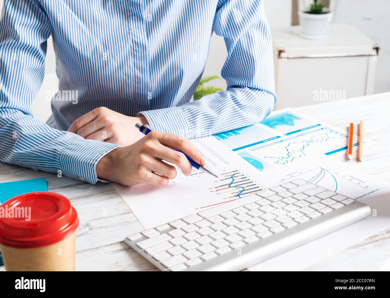 Business consultant sitting at desk Stock Photo - Alamy