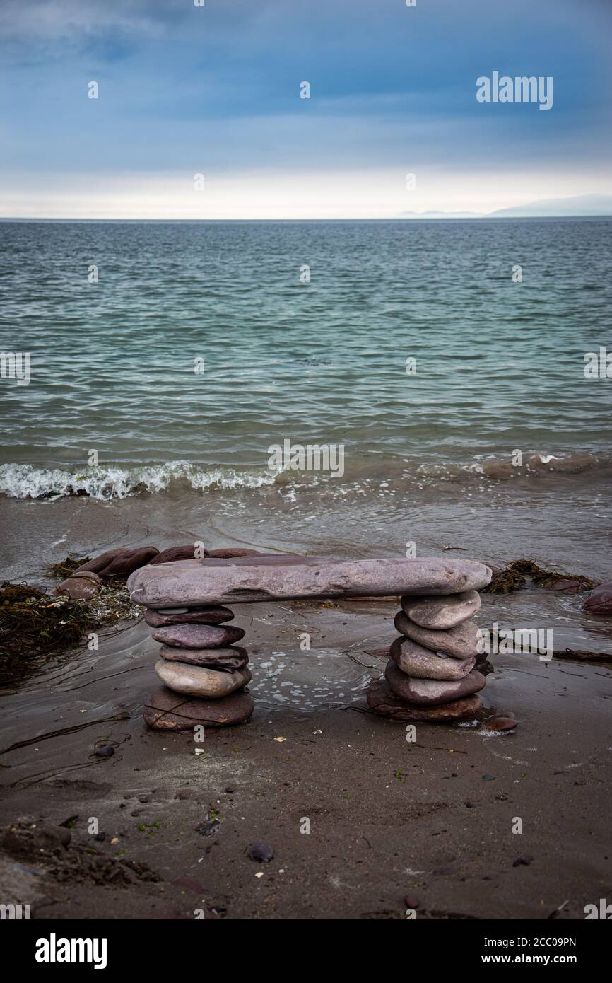 Bench made of stones by the ocean.View of Ireland.Green island Stock ...