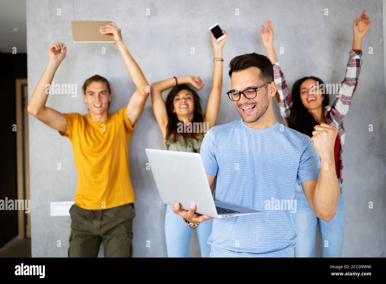 Happy young people working, using digital devices. Technology, people ...