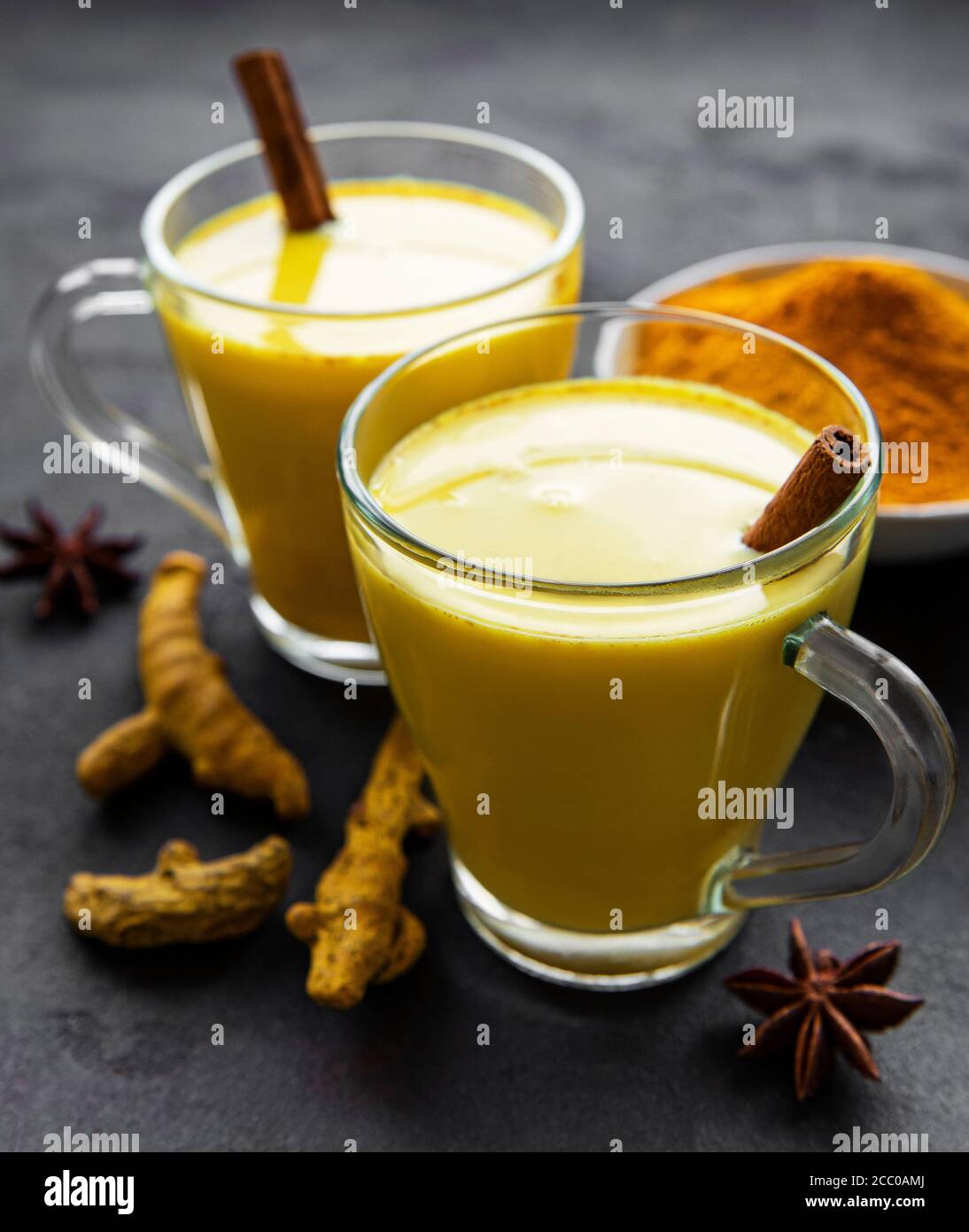 Yellow turmeric latte drink. Golden milk with cinnamon, turmeric ...
