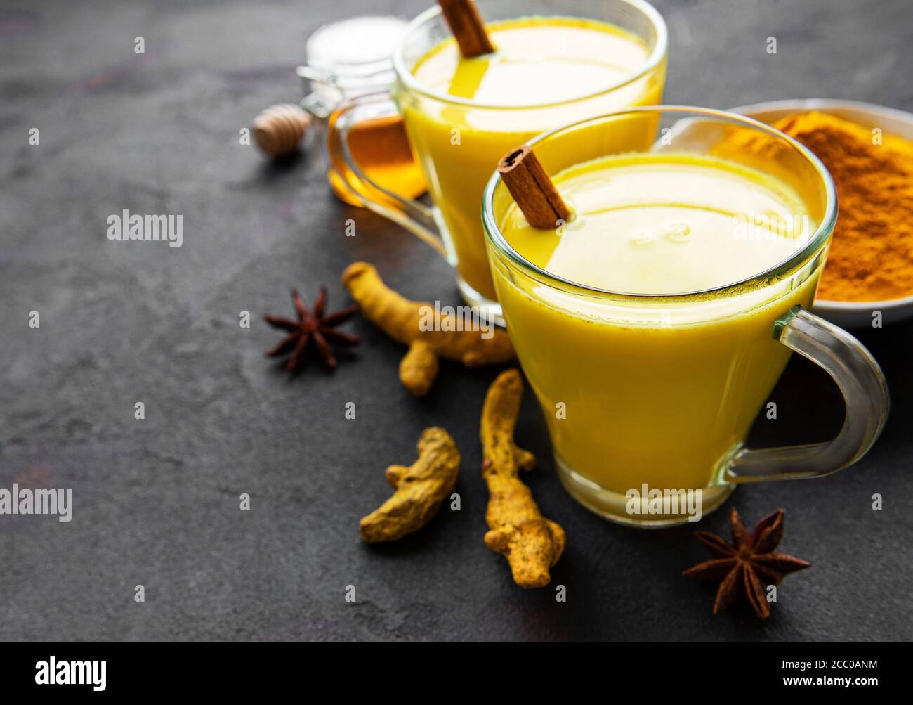 Yellow turmeric latte drink. Golden milk with cinnamon, turmeric ...