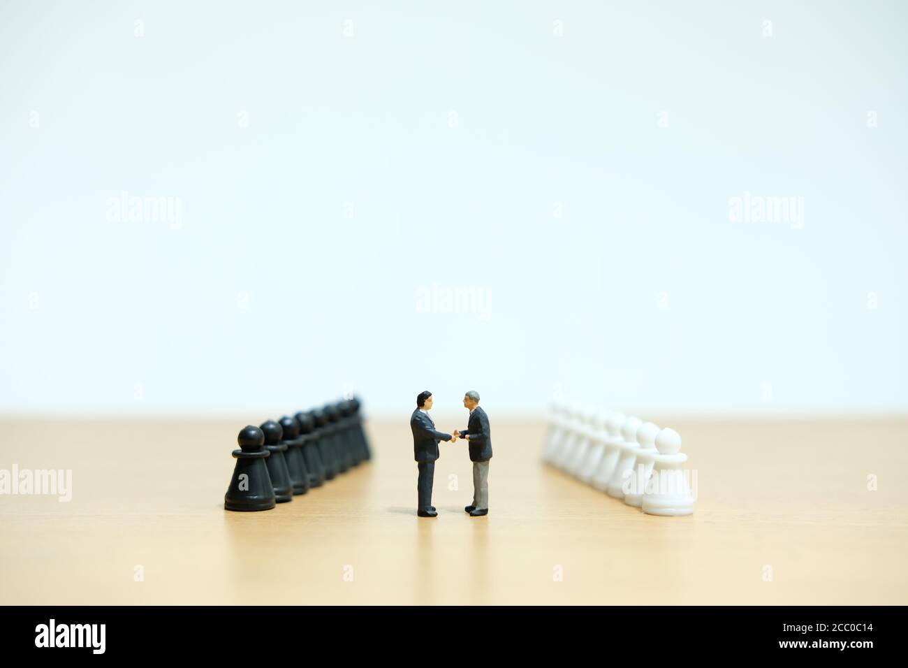 Miniature people strategic concept - businessman make an handshake ...