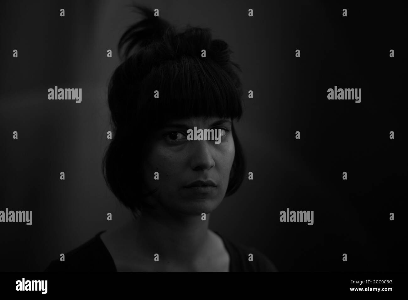 Dramatic portrait of an indian girl on black background Stock Photo - Alamy