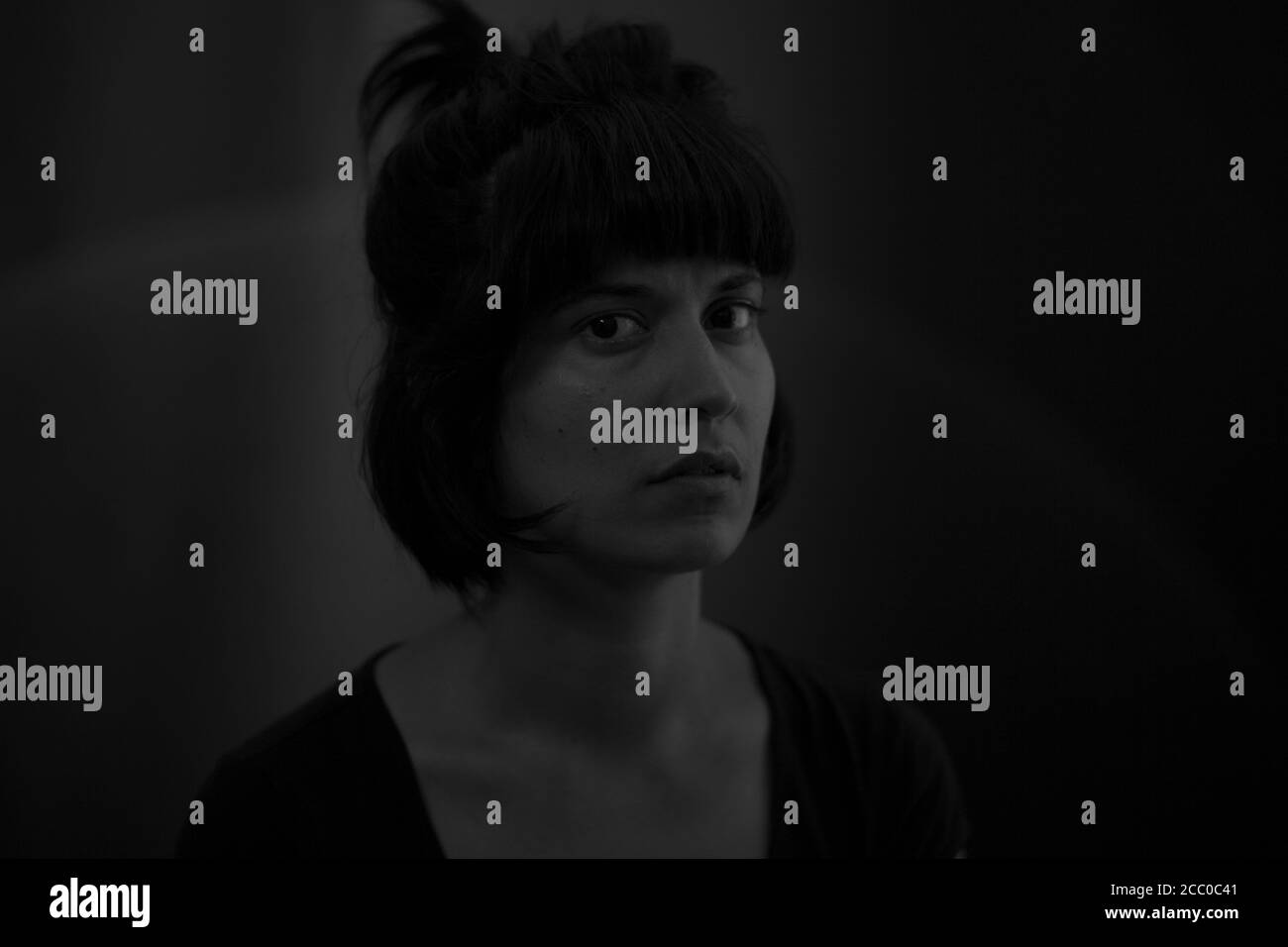 Dramatic portrait of an indian girl on black background Stock Photo - Alamy