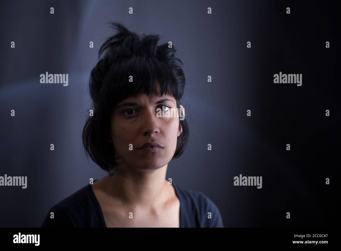 Dramatic portrait of an indian girl on black background Stock Photo - Alamy