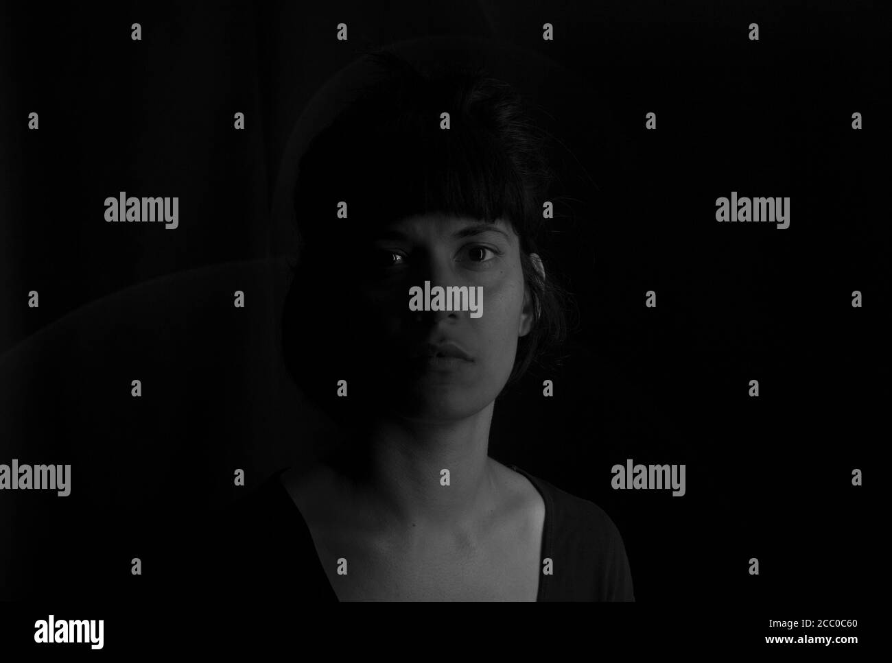 Dramatic portrait of an indian girl on black background Stock Photo - Alamy