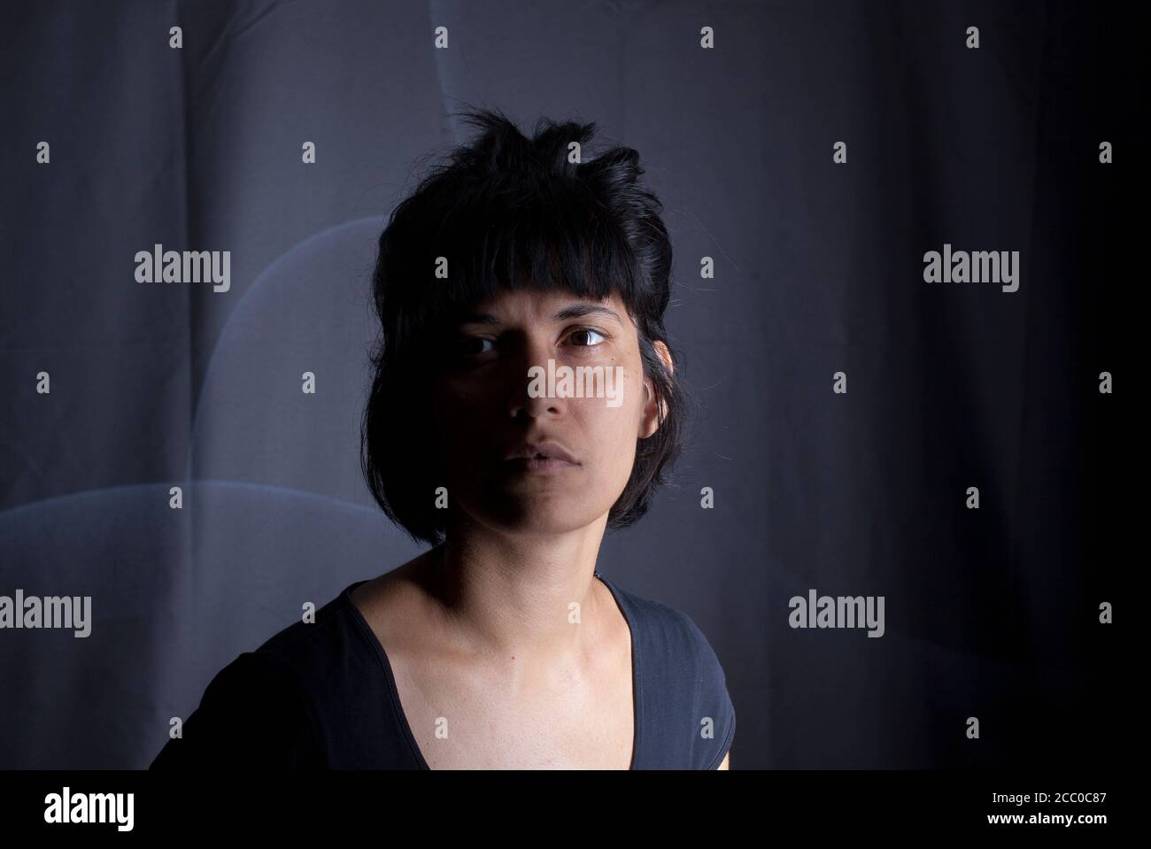 Dramatic portrait of an indian girl on black background Stock Photo - Alamy