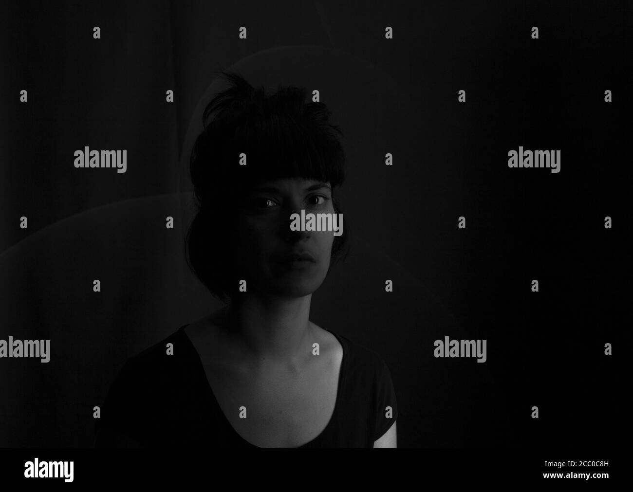Dramatic portrait of an indian girl on black background Stock Photo - Alamy