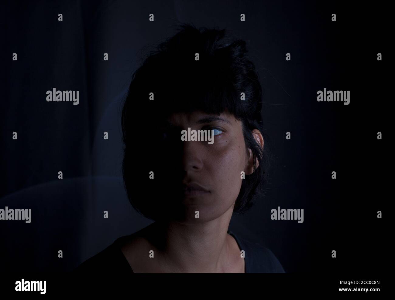 Dramatic portrait of an indian girl on black background Stock Photo - Alamy