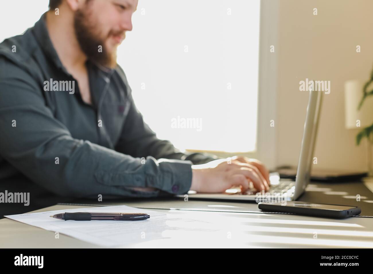 Focus on pen, famous author writing new book using laptop Stock Photo ...