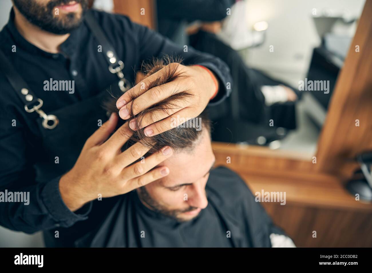 Focused photo on male hands touching hair Stock Photo - Alamy