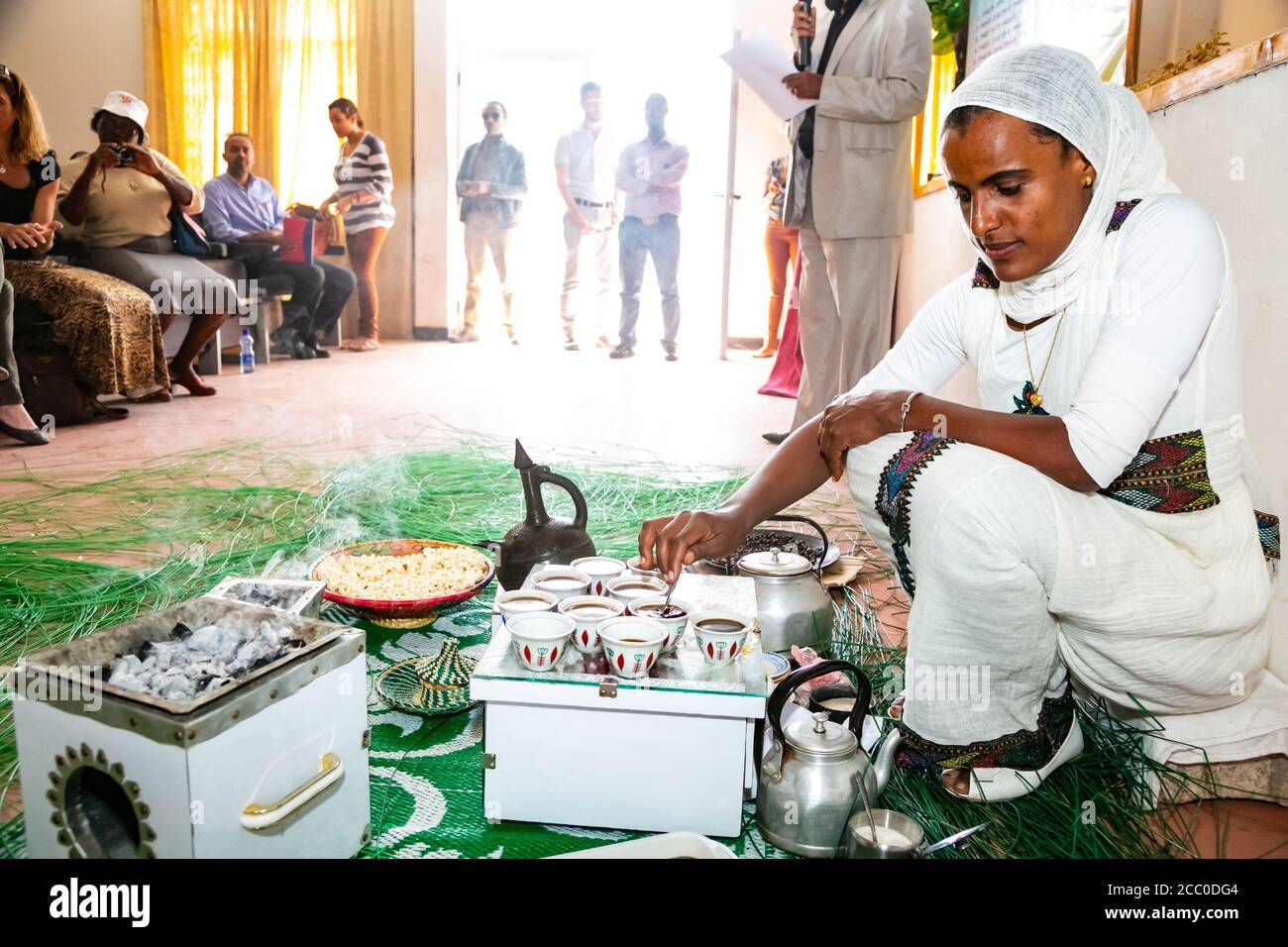 Addis Ababa, Ethiopia - January 30, 2014: African woman preparing cups ...