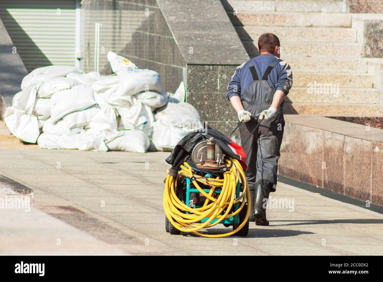 worker pulls a hose pumping station construction technology Stock Photo ...