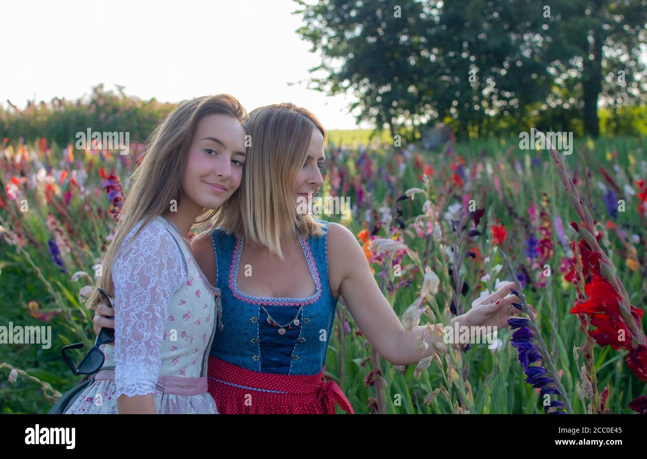 Two bavarian women having fun in nature Stock Photo - Alamy