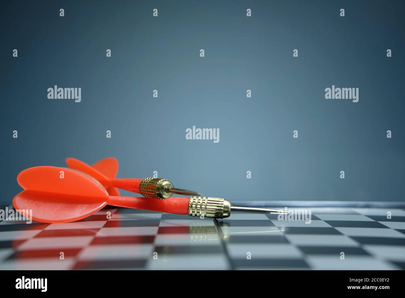 Red dart arrow laying on chess board with dark grey background Stock ...