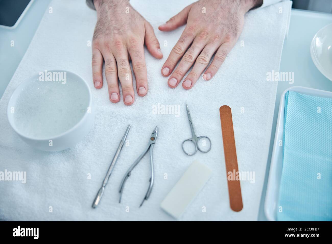 Top view picture of male hands lying on the towel Stock Photo - Alamy