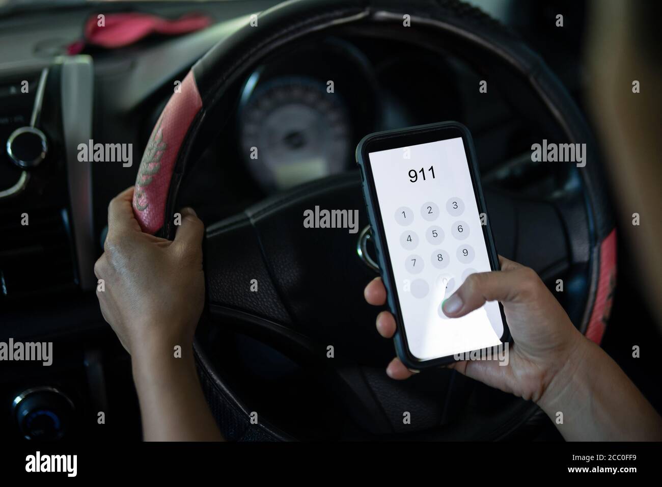 Hand holding cell phone with emergency number 911 in car Stock Photo ...