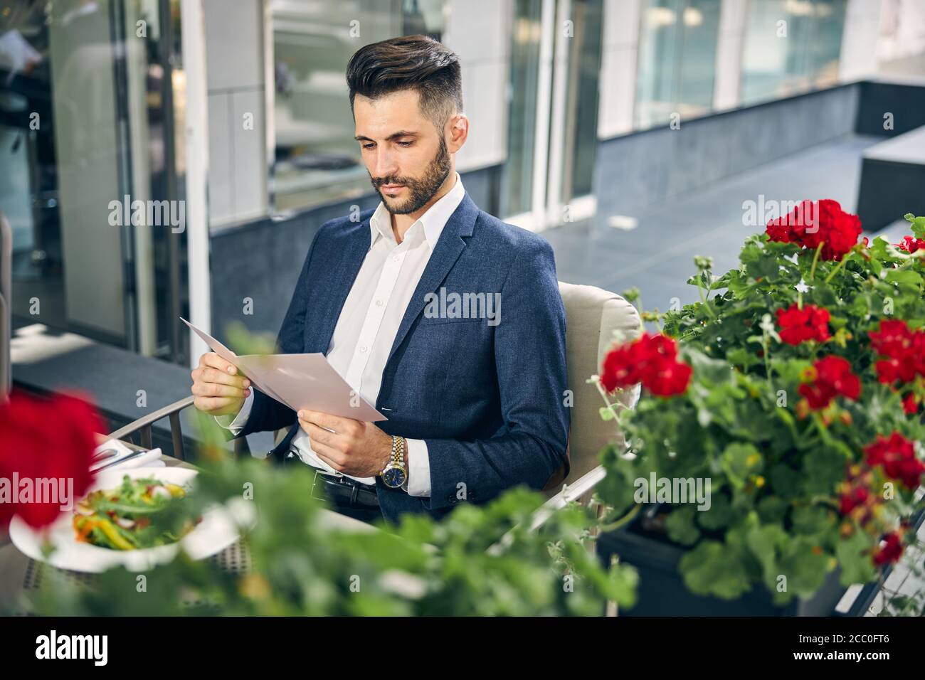 Relaxed male person having lunch in cafe Stock Photo - Alamy