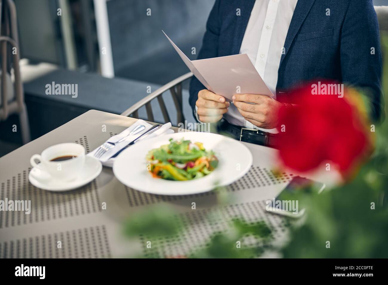 Hands holding menu hi-res stock photography and images - Alamy