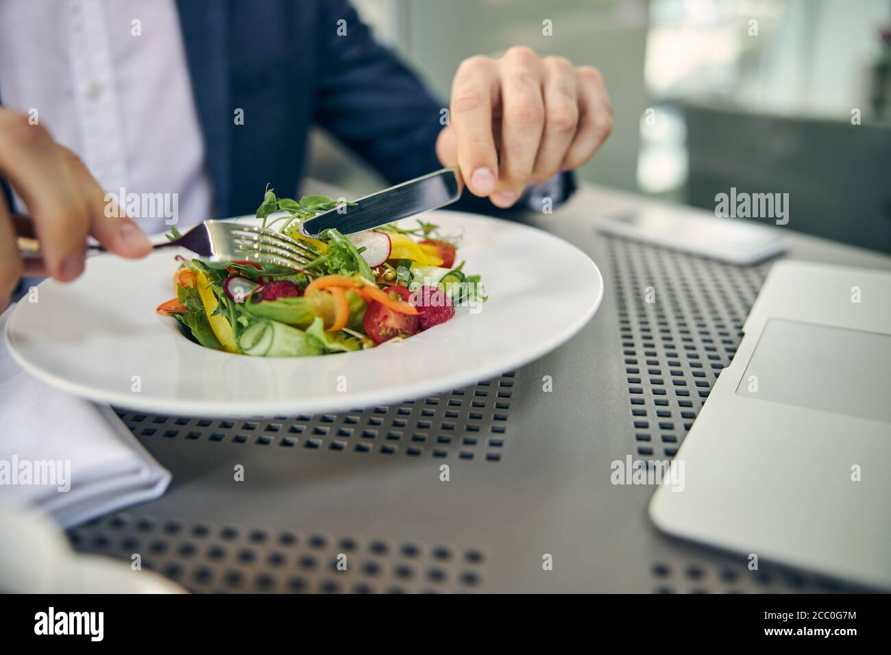Focused photo on young man eating his dinner Stock Photo - Alamy