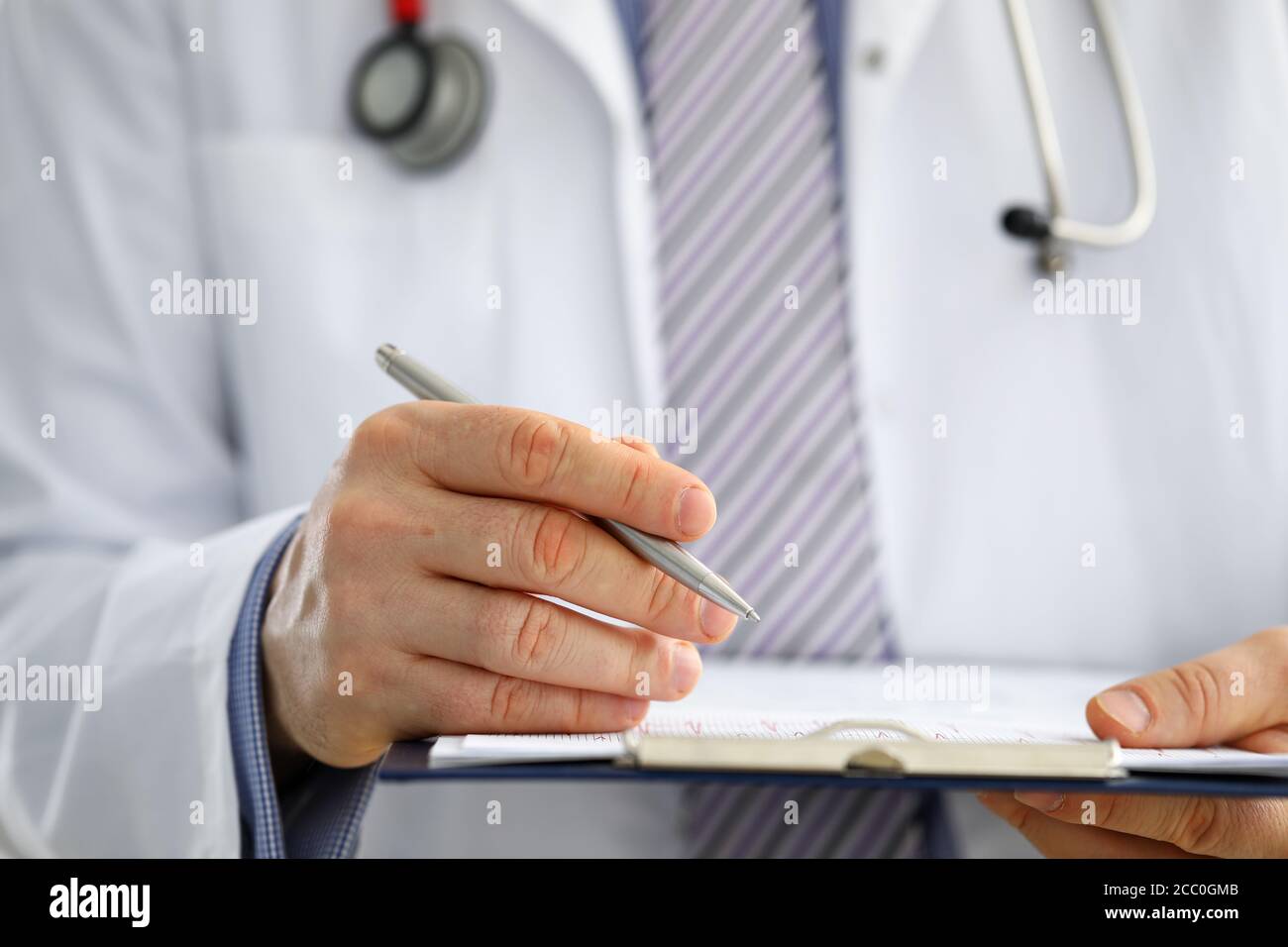 Male medicine doctor hand holding silver pen Stock Photo - Alamy