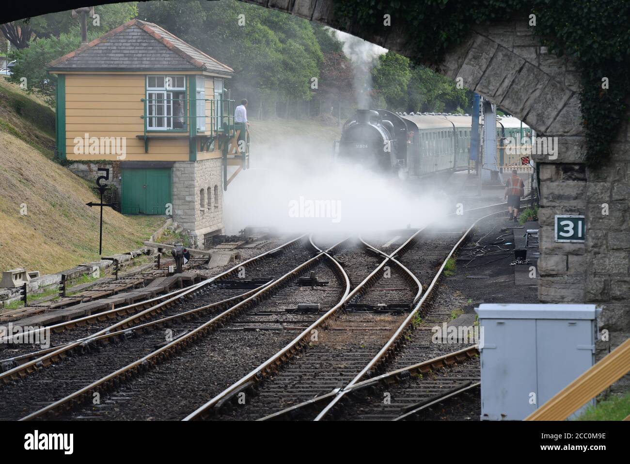 A U class locomotive pulling a steam train under a road bridge Stock ...