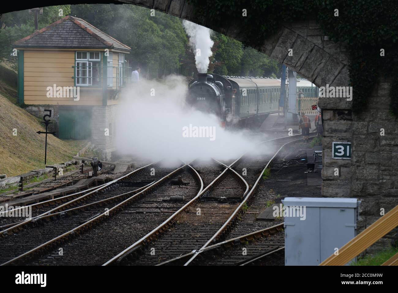 A U class locomotive pulling a steam train under a road bridge Stock ...