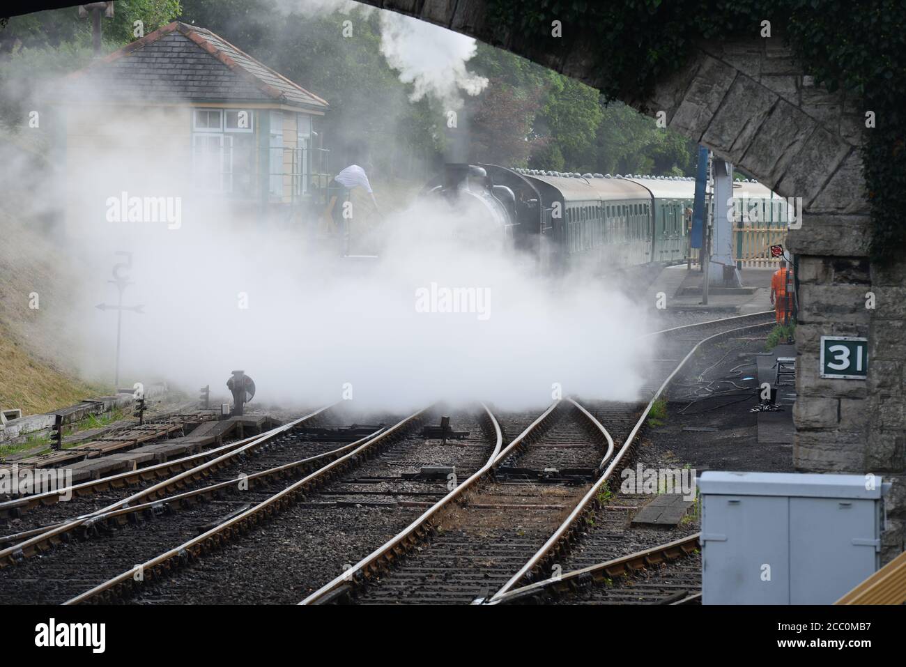 A U class locomotive pulling a steam train under a road bridge Stock ...