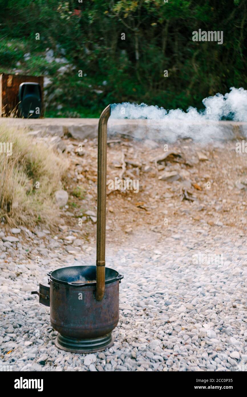 Metal cauldron for pilaf with chimney Stock Photo - Alamy
