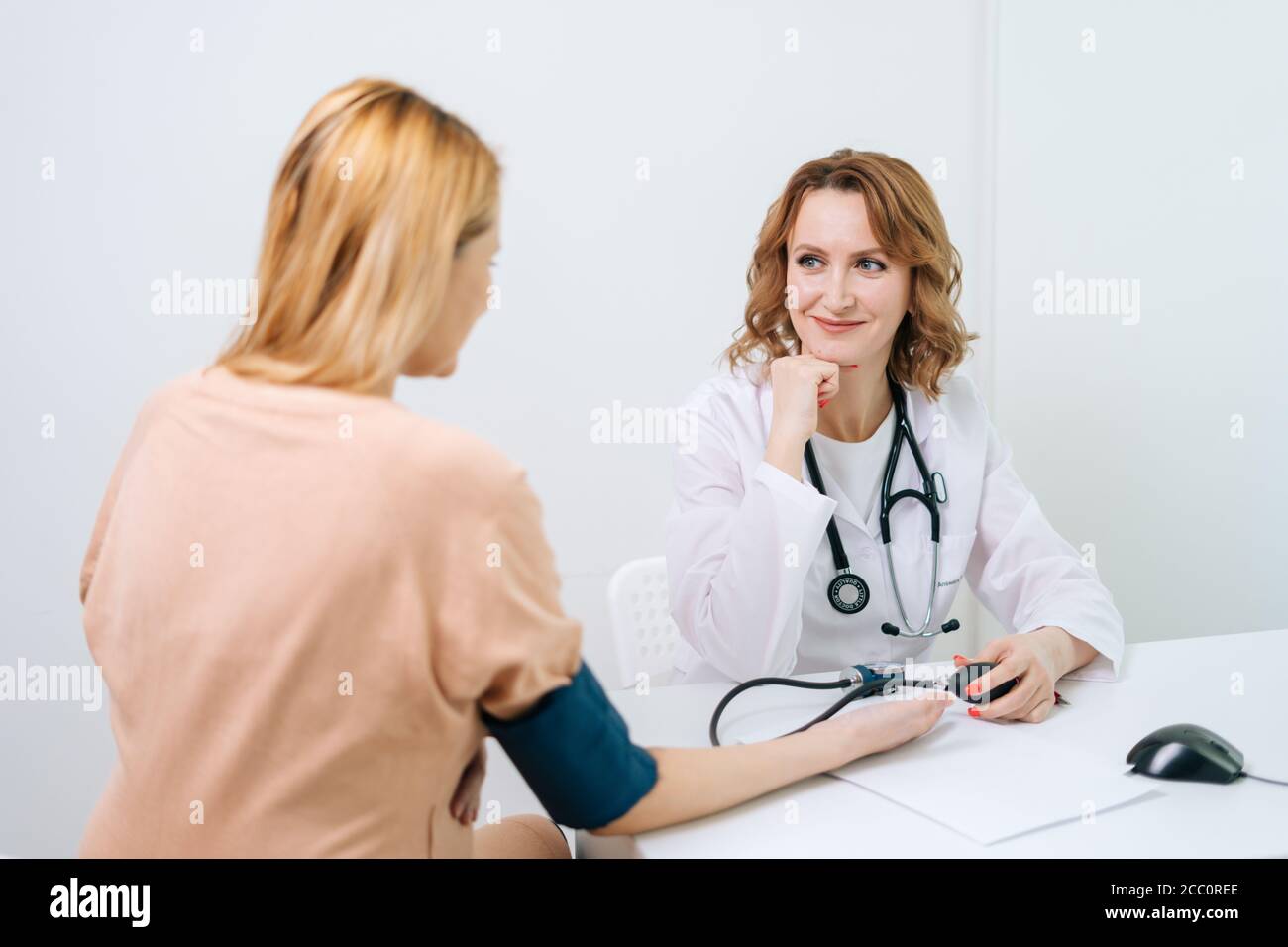 Professional female doctor check-up young pregnant woman patient pulse ...