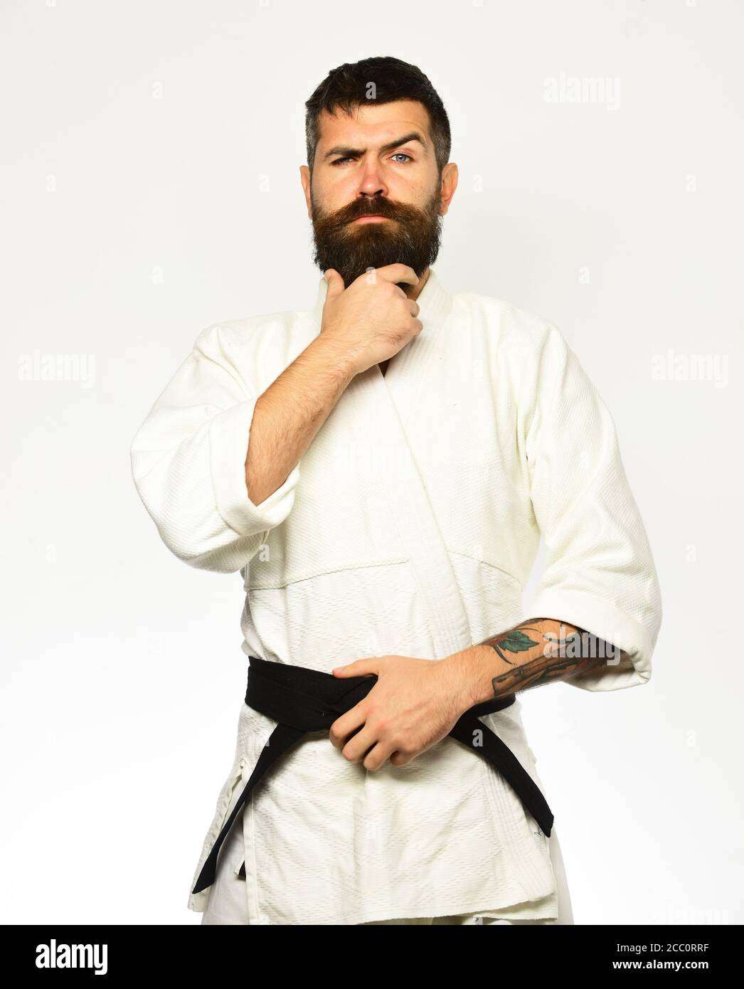 Man with beard in white kimono on white background. Karate man with ...