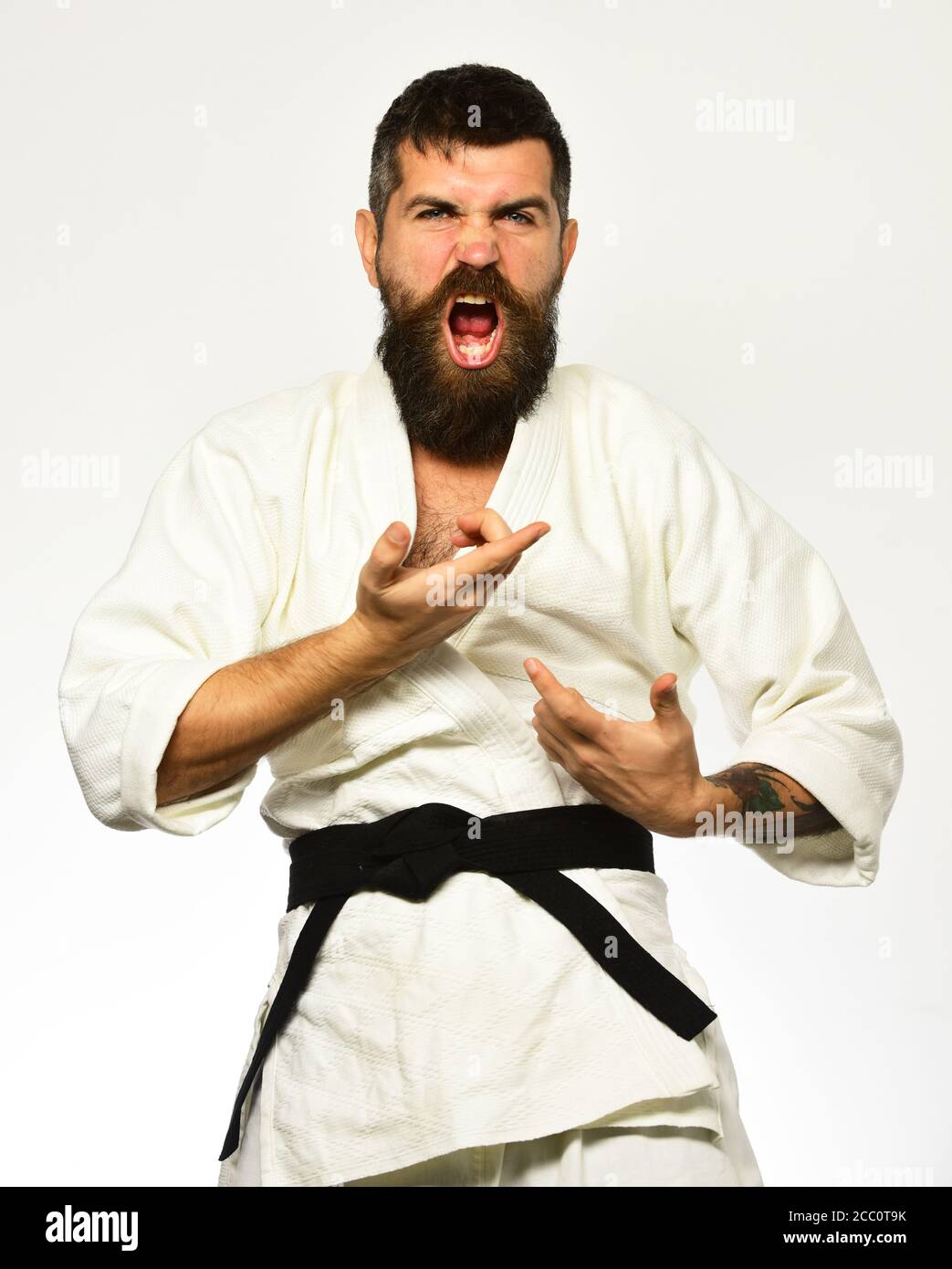 Training and combat concept. Man with beard in white kimono on white ...