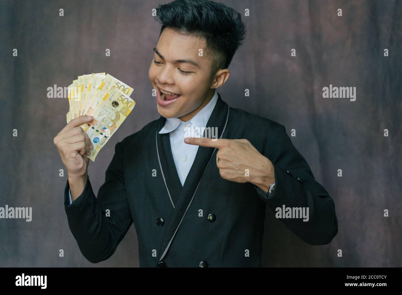 Successful Businessman Happily Holding a lot of Philippine Money ...