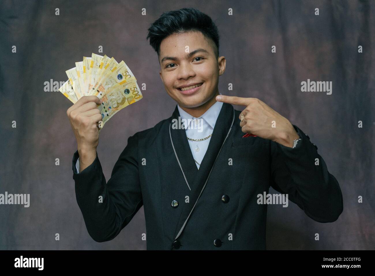 Successful Businessman Happily Holding a lot of Philippine Money ...