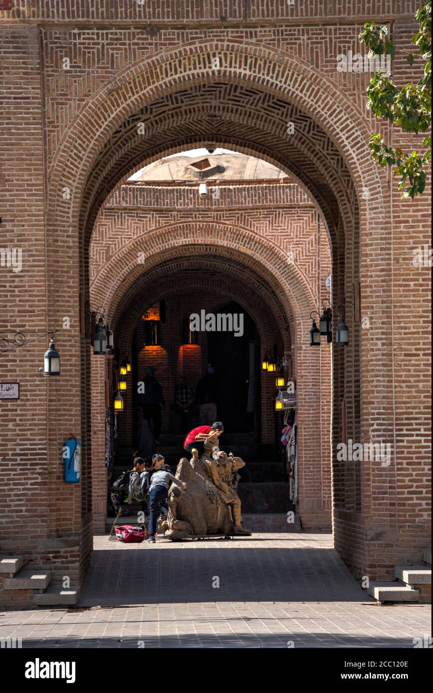 Children playing in one of the courtyards of the Qazvin bazaar in an ...
