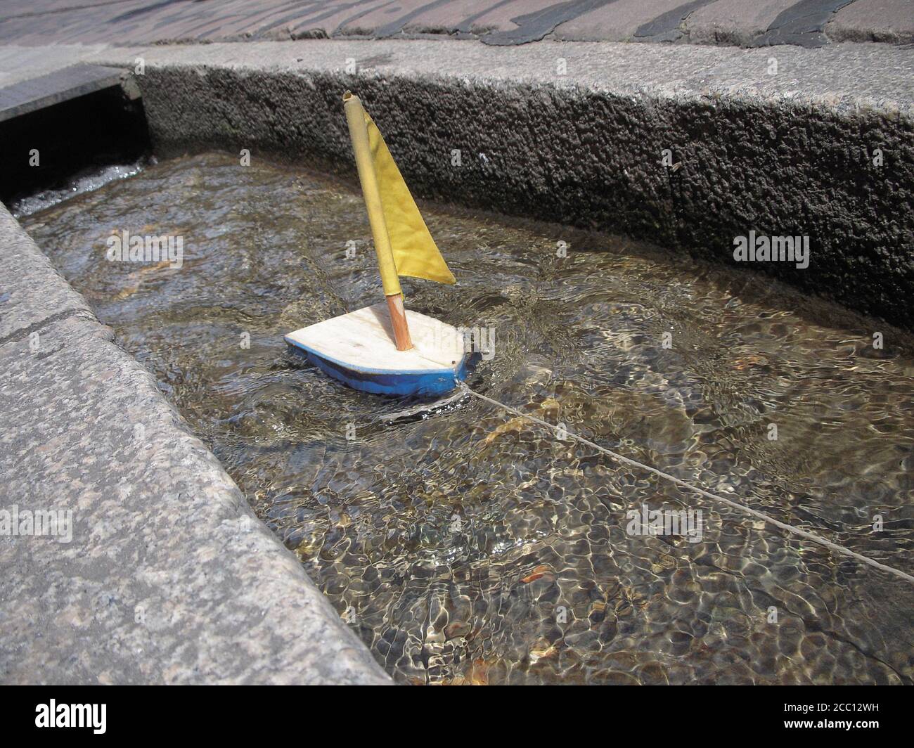Canal in Freiburg (Germany) with a small toy boat Stock Photo - Alamy