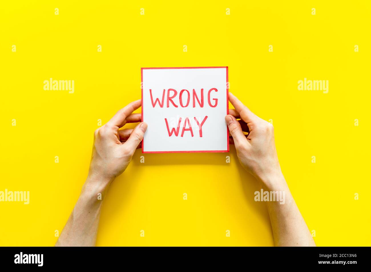 Business failure. Wrong way icon in hands on office desk top-down Stock ...