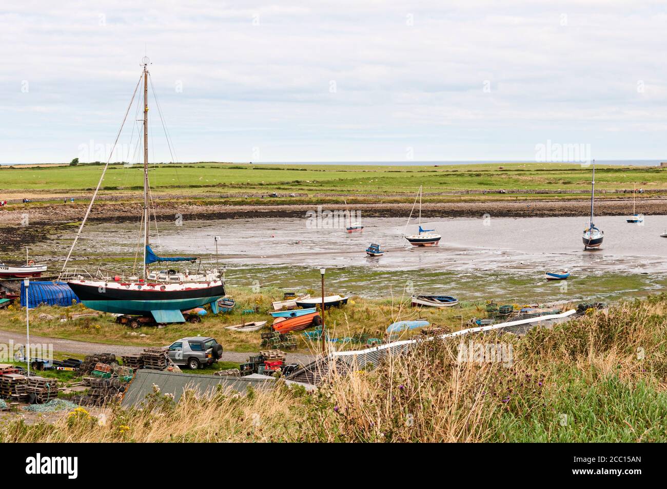 A large yacht stands on a trailer alongside the harbour of Holy Island ...